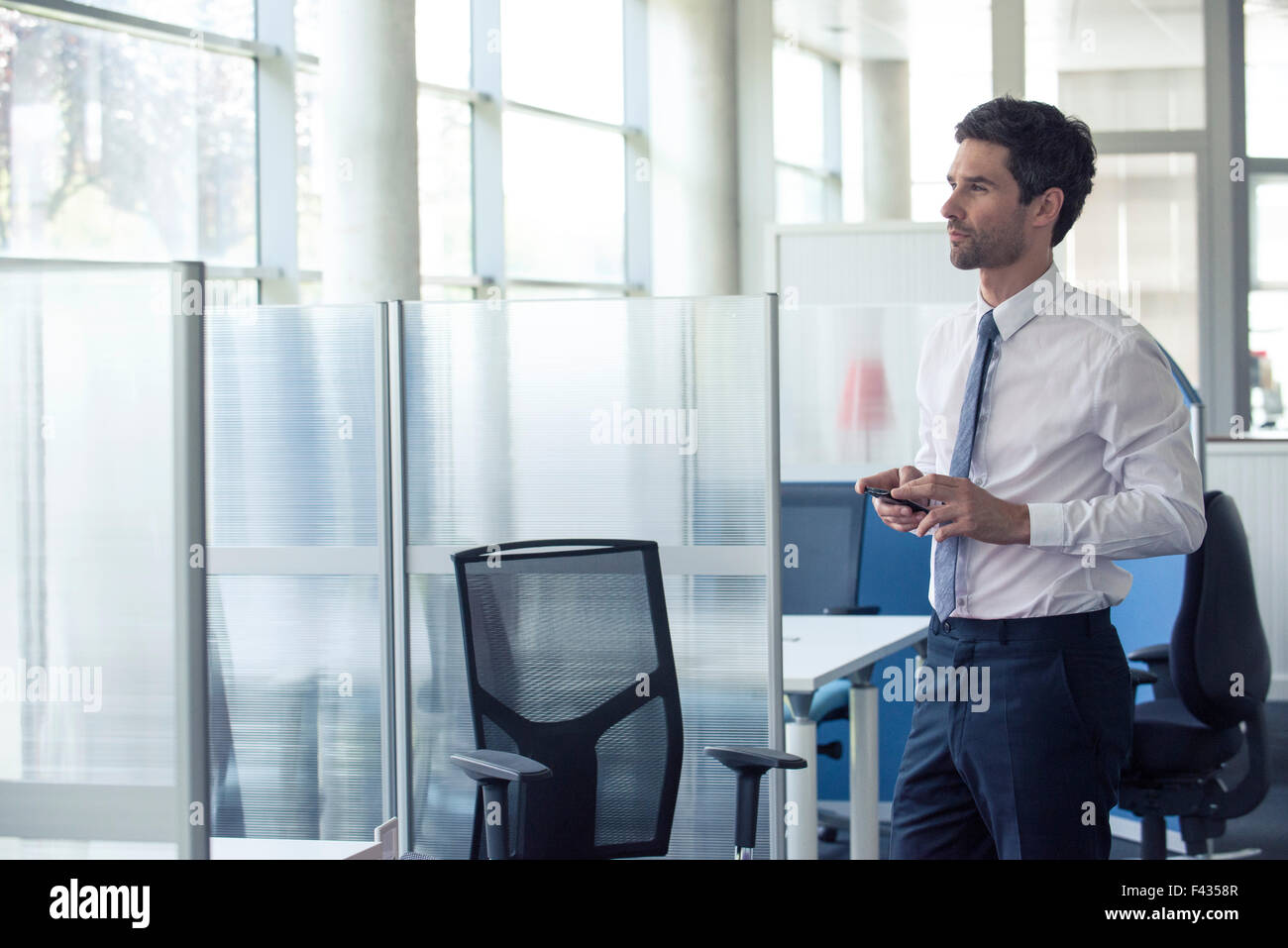 Office worker on break looking out window Stock Photo - Alamy