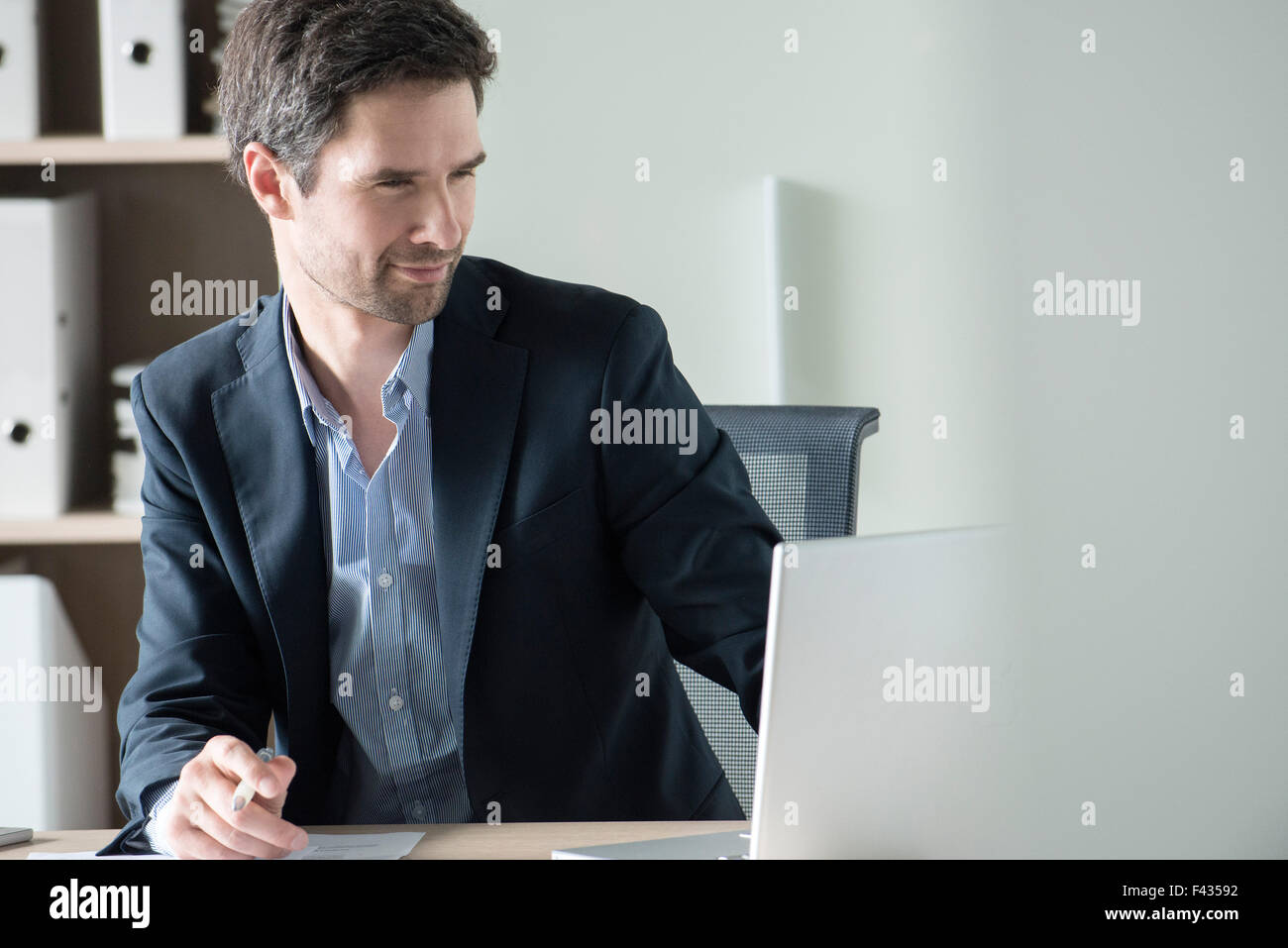 Entrepreneur using laptop Stock Photo - Alamy