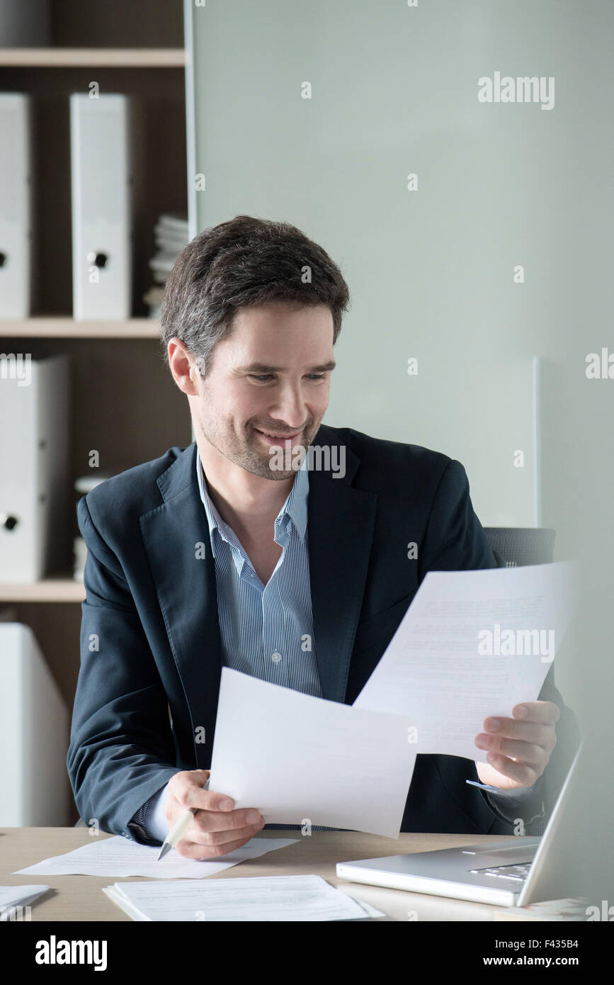 Businessman reviewing paperwork Stock Photo - Alamy Businessman reviewing paperwork Stock Photo - Alamy