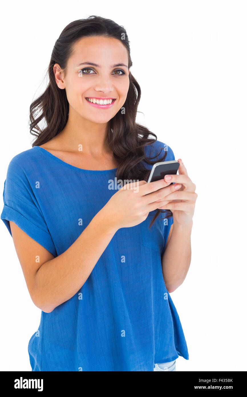 Pretty brunette sending a text Stock Photo - Alamy