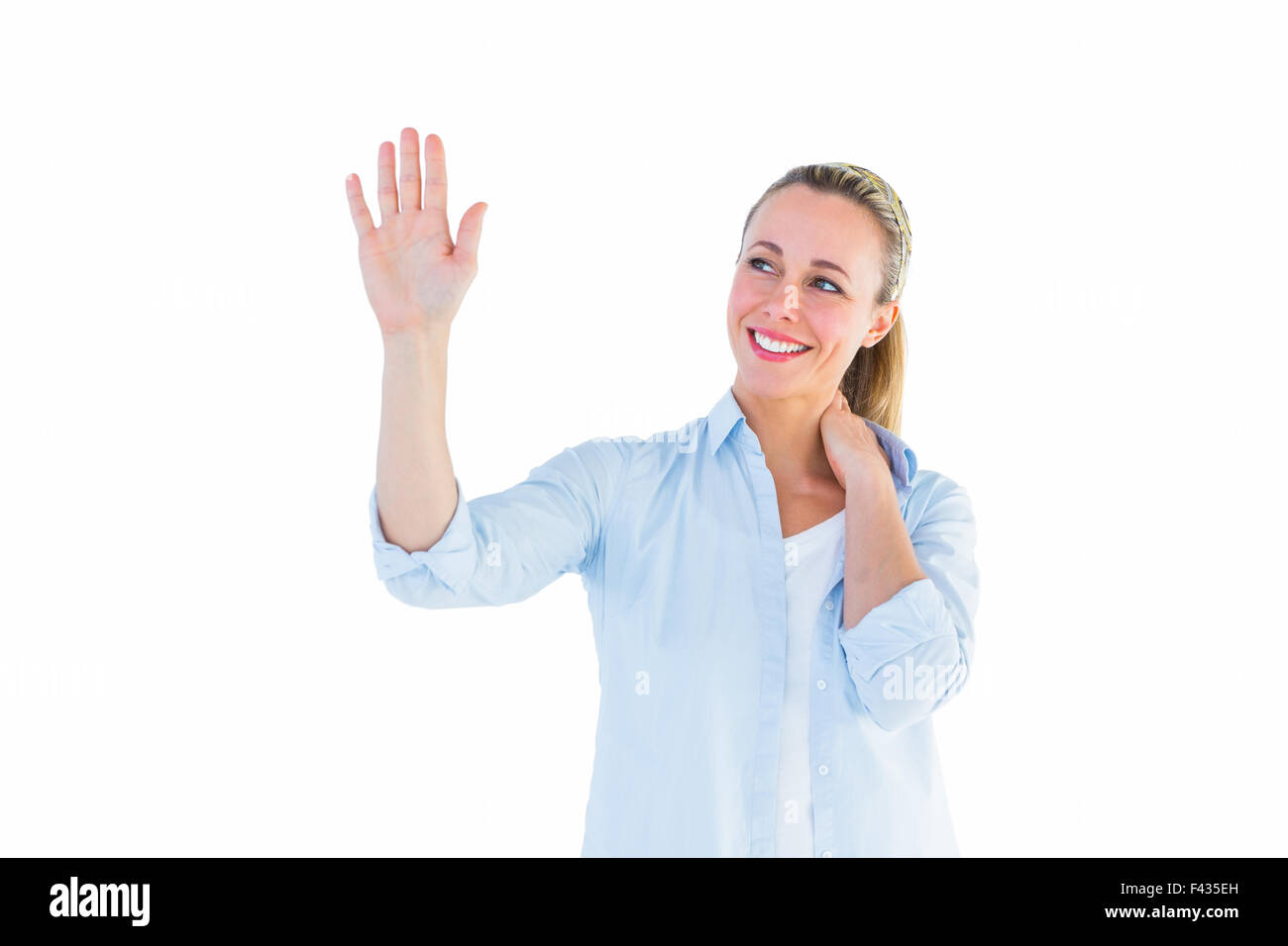 Blonde woman with hand raised Stock Photo - Alamy