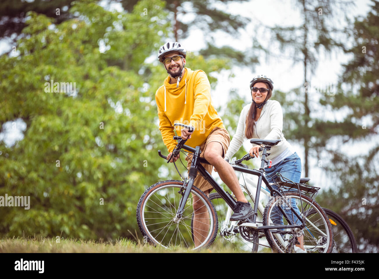 Happy couple on a bike ride Stock Photo - Alamy