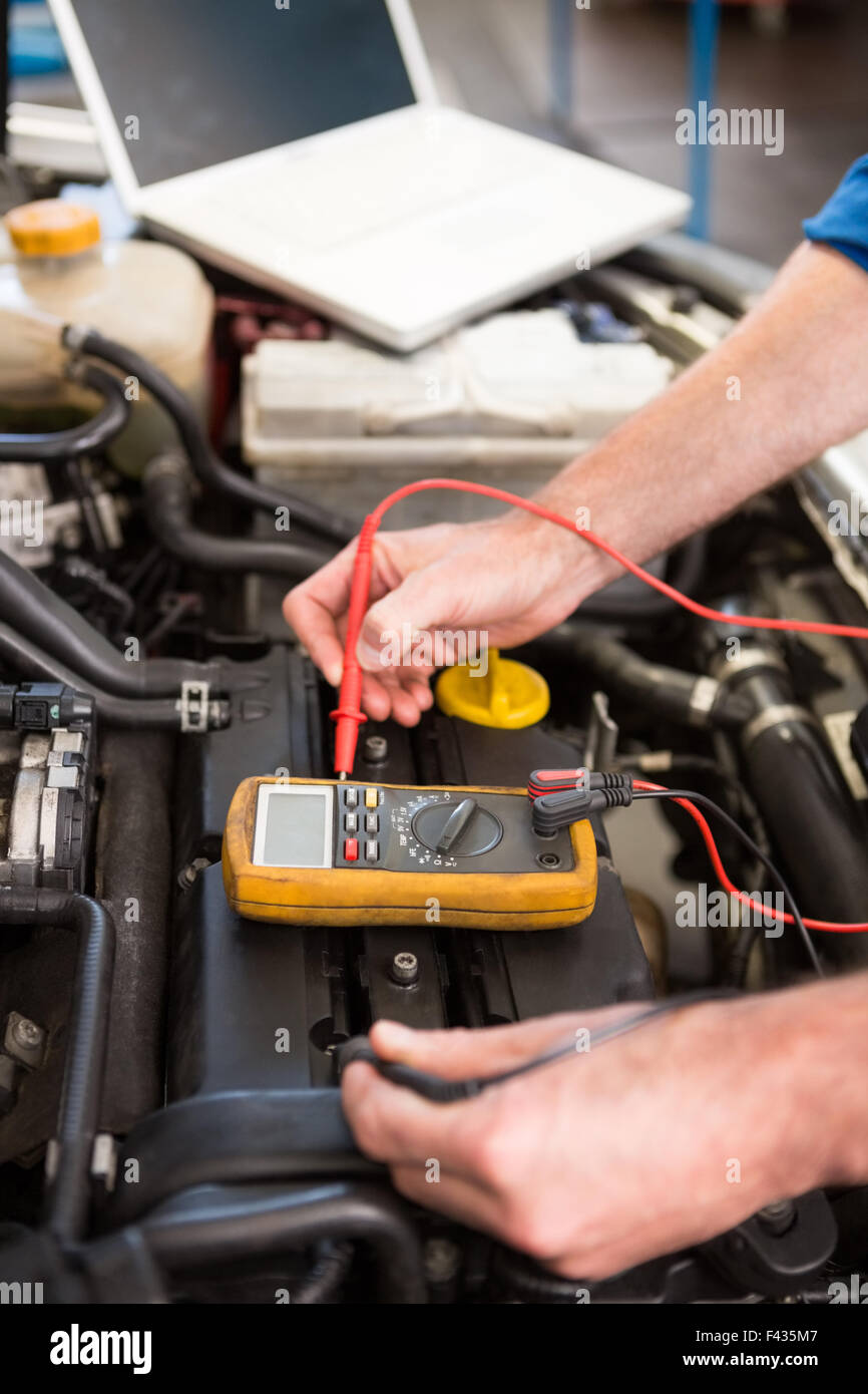 Mechanic using diagnostic tool on engine Stock Photo - Alamy