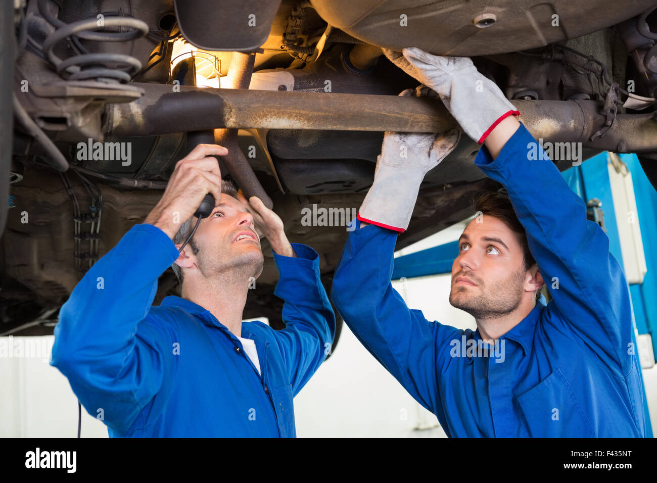 Team of mechanics working together Stock Photo - Alamy