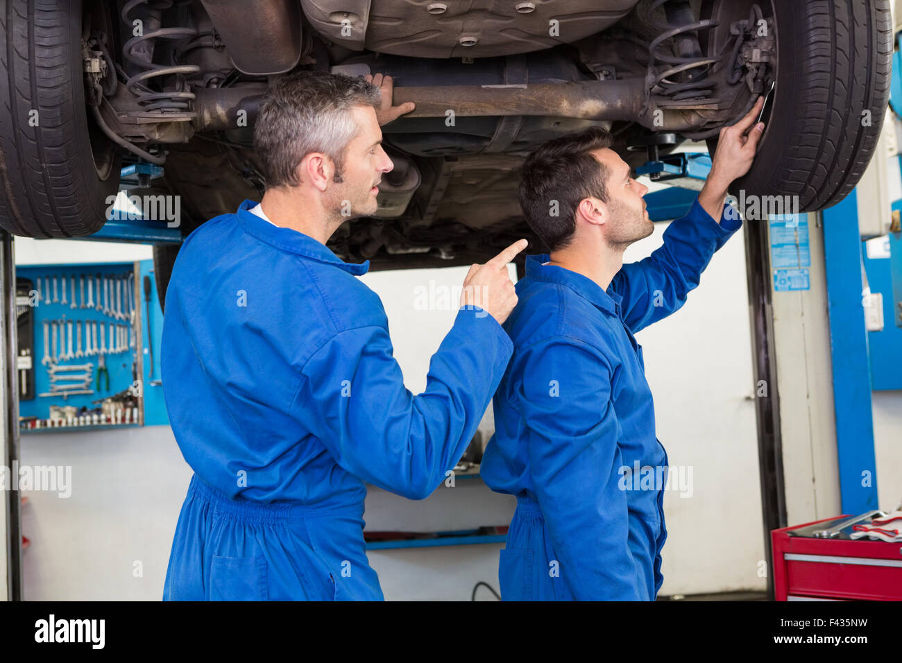 Team of mechanics working together Stock Photo - Alamy
