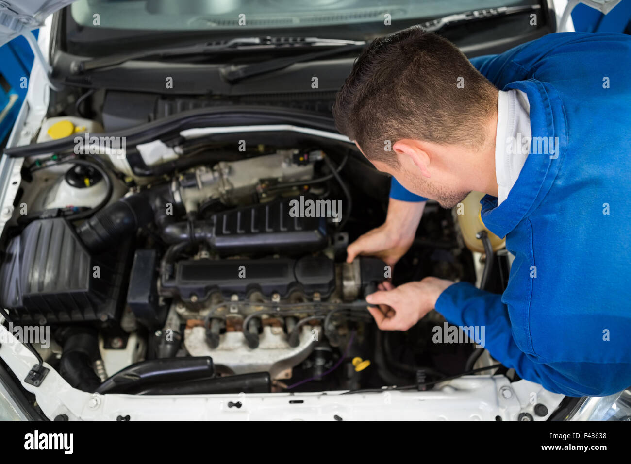 Mechanic working on an engine Stock Photo - Alamy