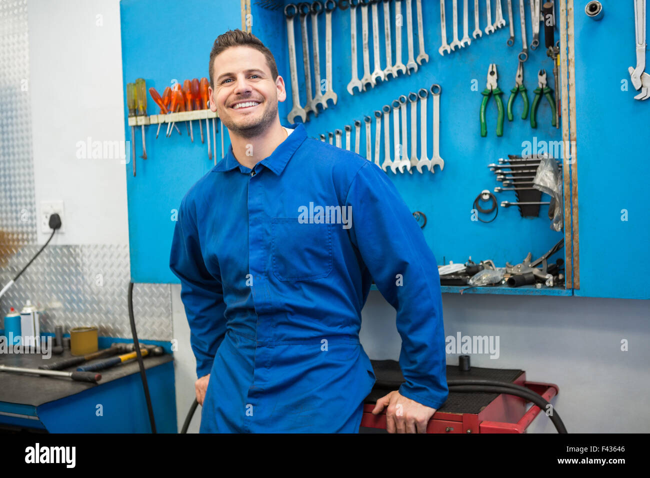 Smiling mechanic looking at camera Stock Photo - Alamy
