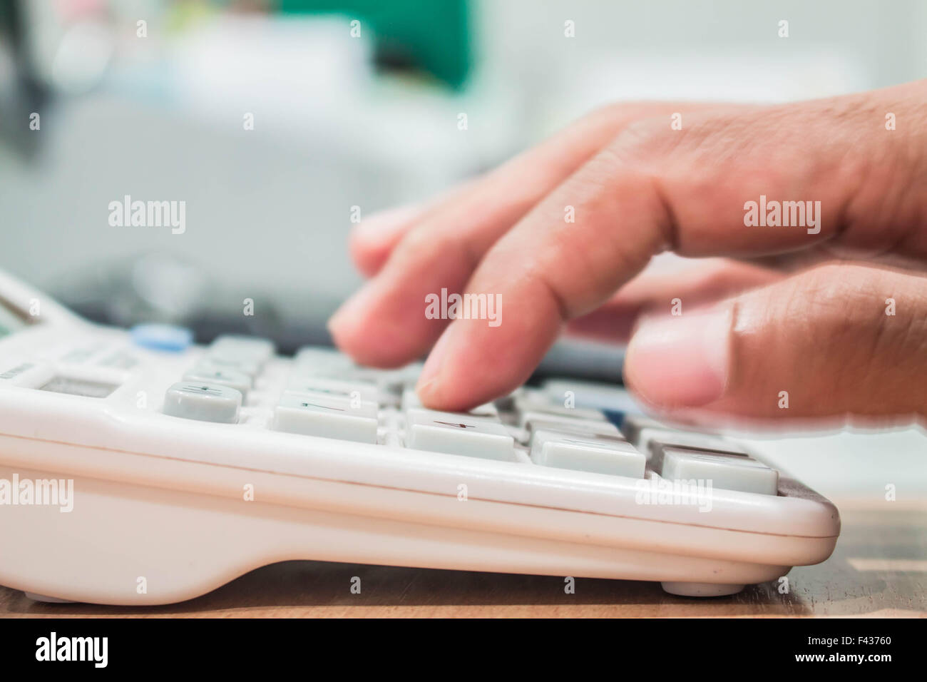 Calculator and a hand that was pressing on a calculator Stock Photo - Alamy