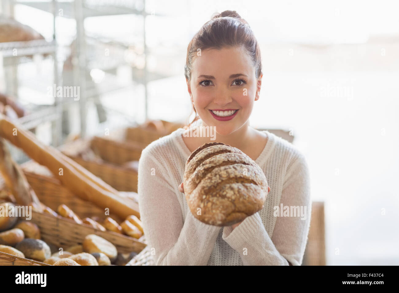 Pretty brunette showing loaf of bread Stock Photo - Alamy