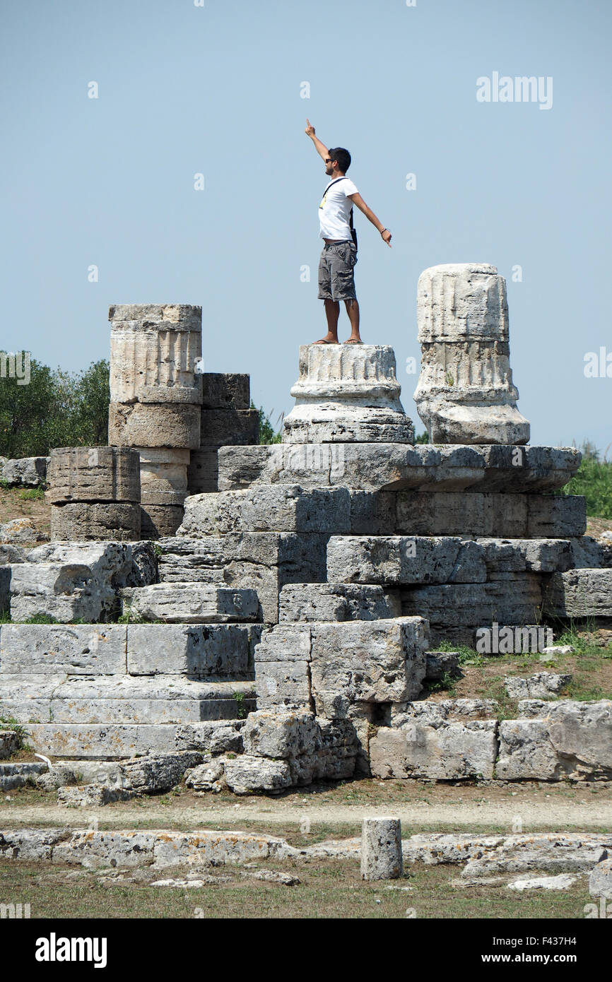 A young male adult posing on ancient Greek Ruins in Paestum Stock Photo ...