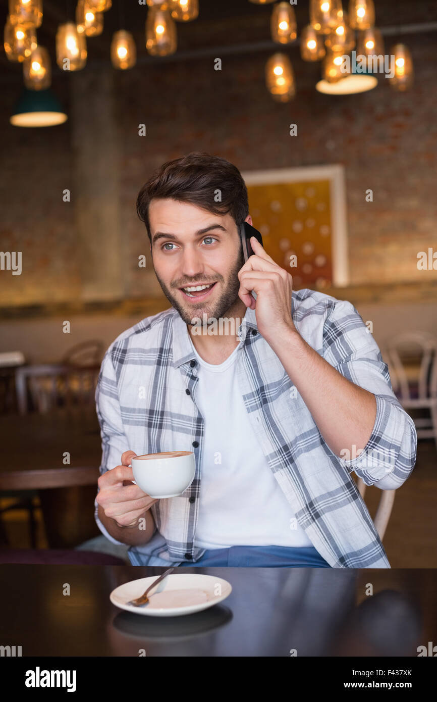 Young man having cup of coffee Stock Photo - Alamy