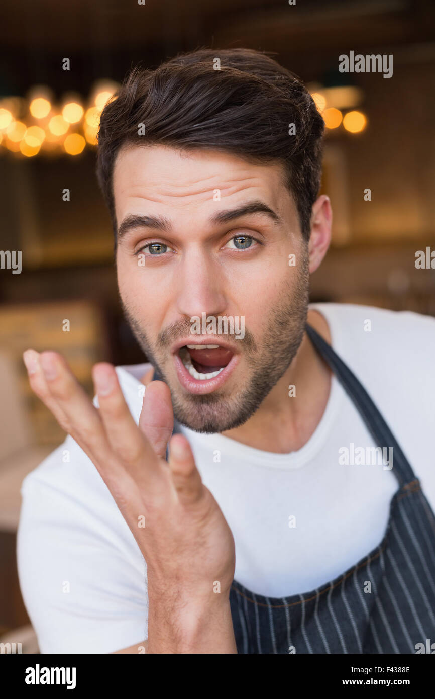 Handsome waiter making tasty gesture Stock Photo - Alamy