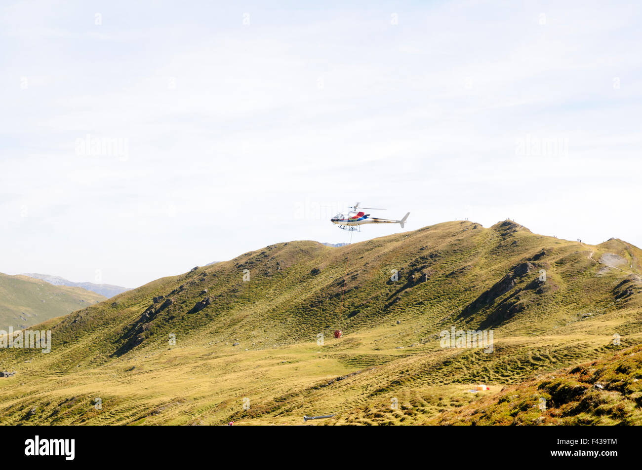 Construction Helicopter carries a load of concrete to pour the ...