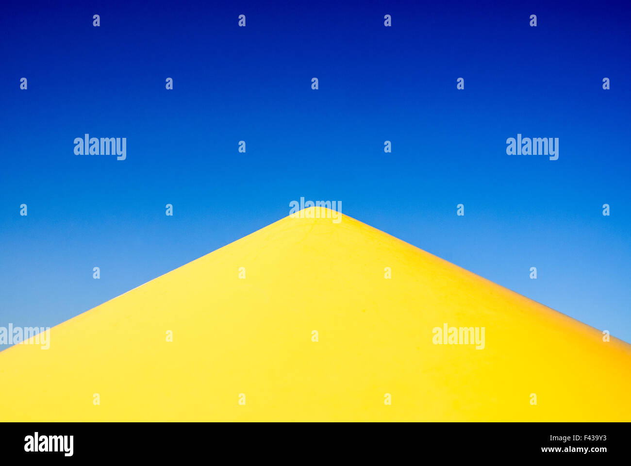 Yellow cone in front of blue sky Stock Photo - Alamy