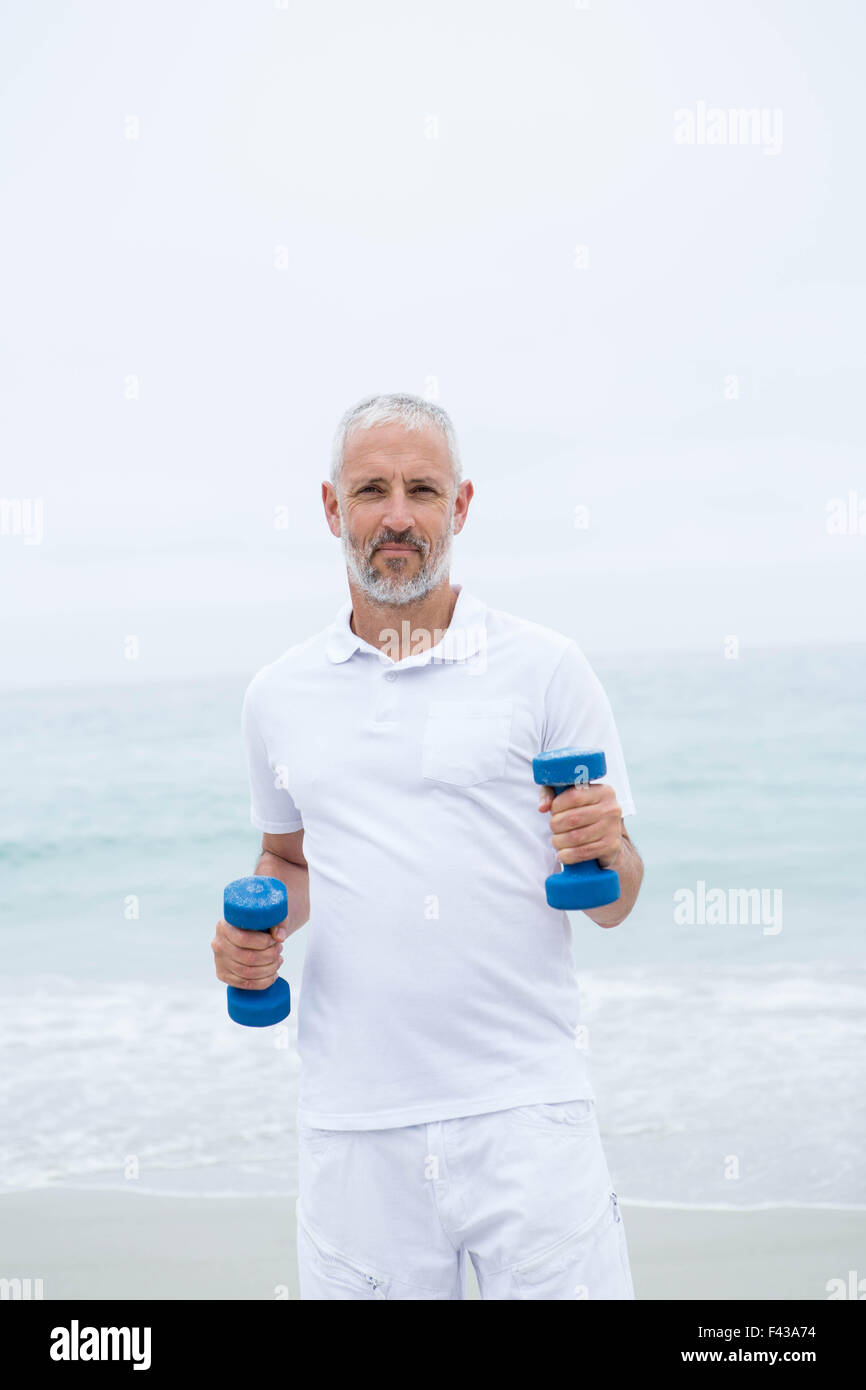 Fit man lifting dumbbells Stock Photo - Alamy