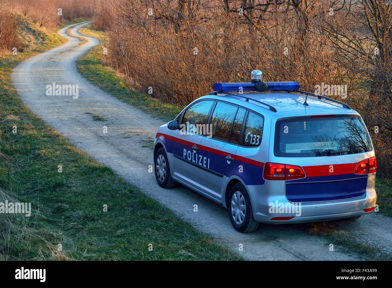 Police car drives along a path Stock Photo - Alamy