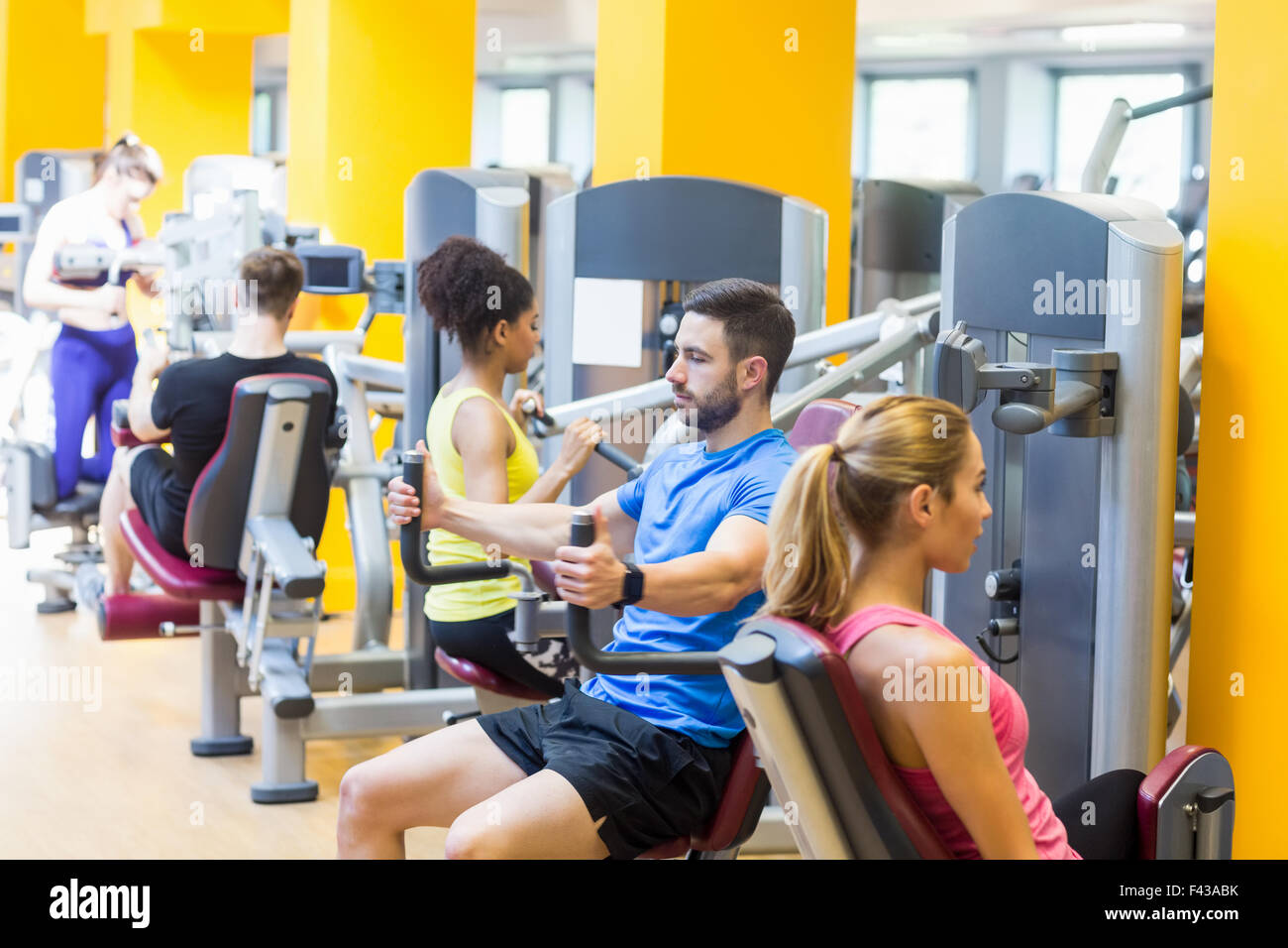 Fit people using weights machines Stock Photo - Alamy