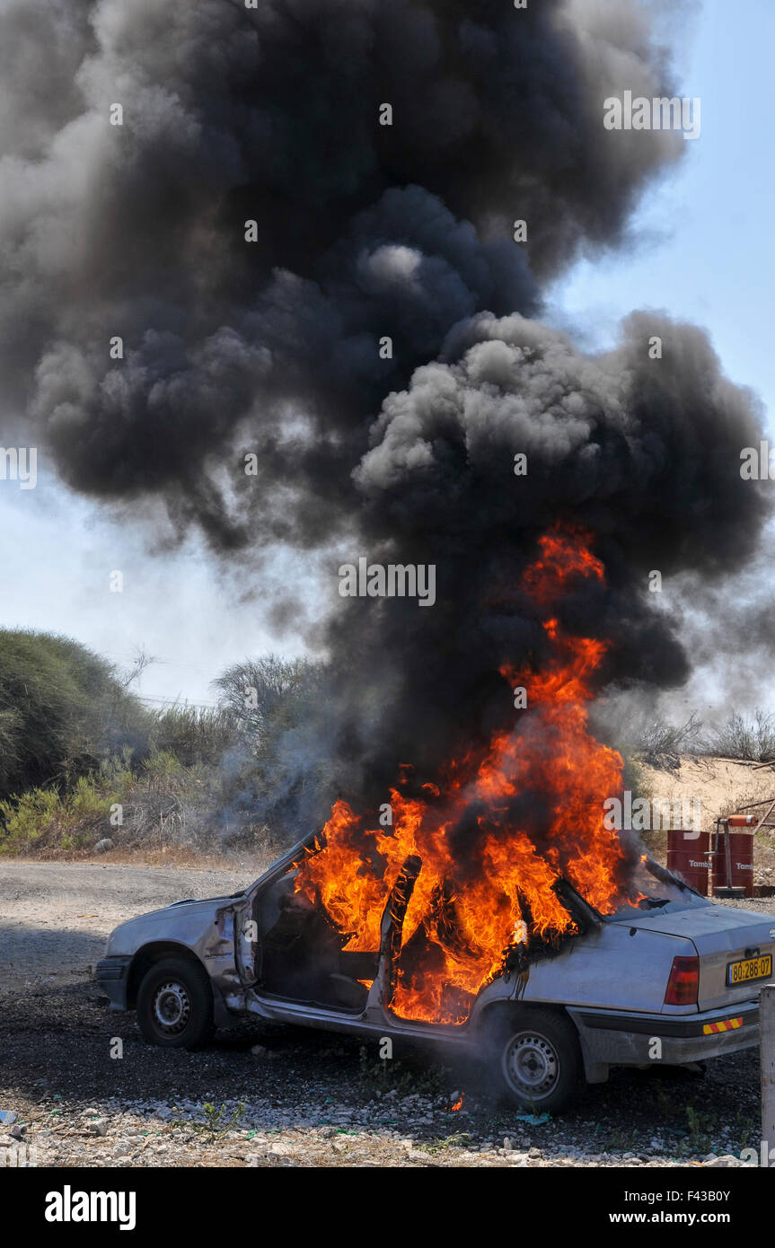 Firefighters extinguish a burning car Stock Photo - Alamy