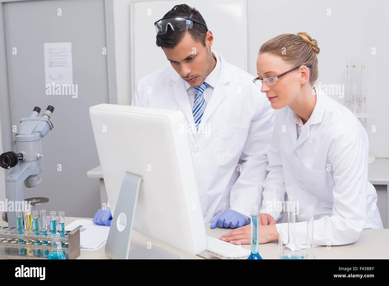 Scientists looking at computer Stock Photo - Alamy
