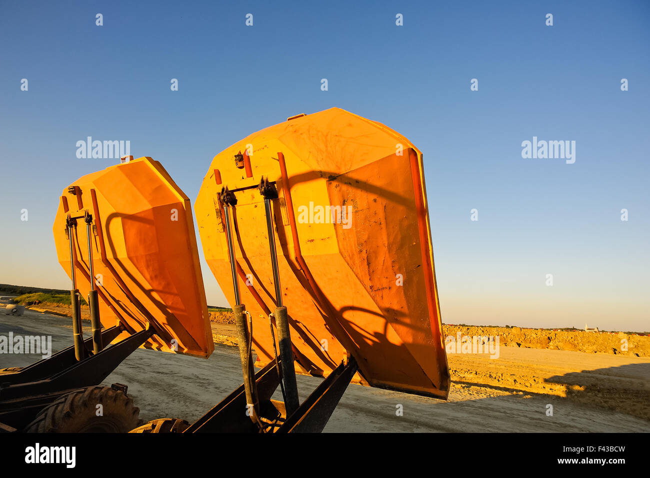 Dump trucks at construction site Stock Photo - Alamy