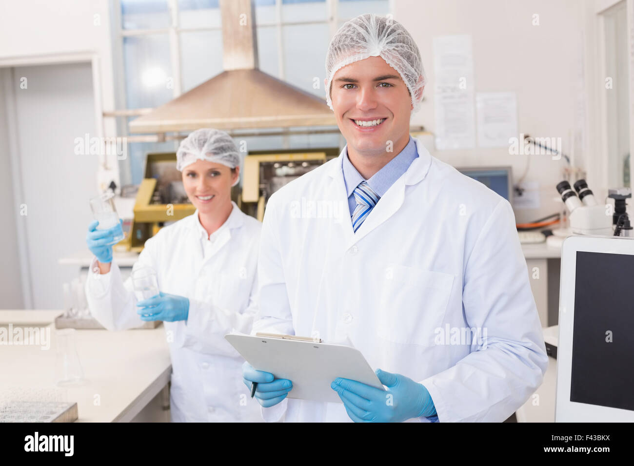 Smiling scientists looking at camera Stock Photo - Alamy