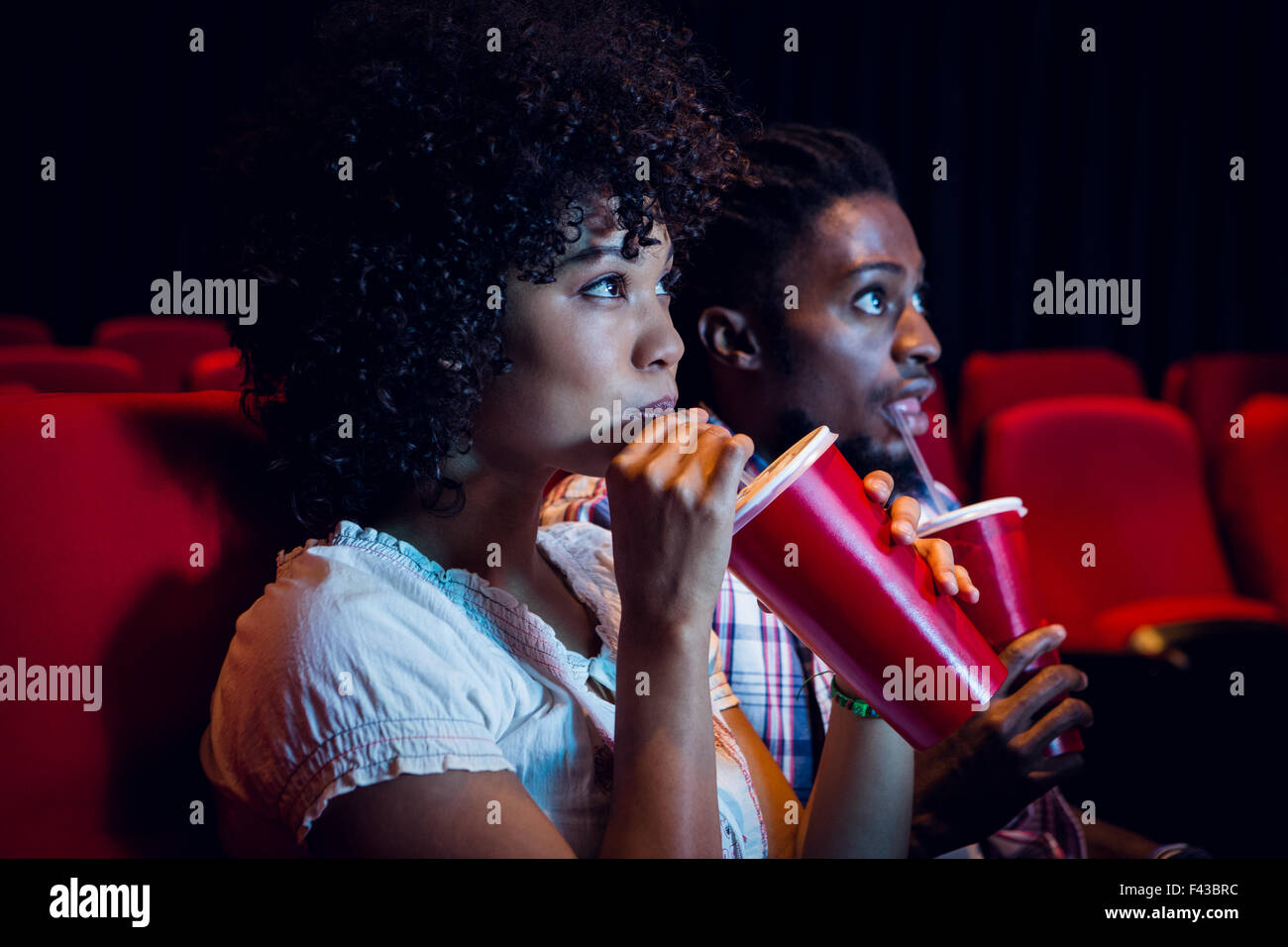 Young couple watching a film Stock Photo - Alamy