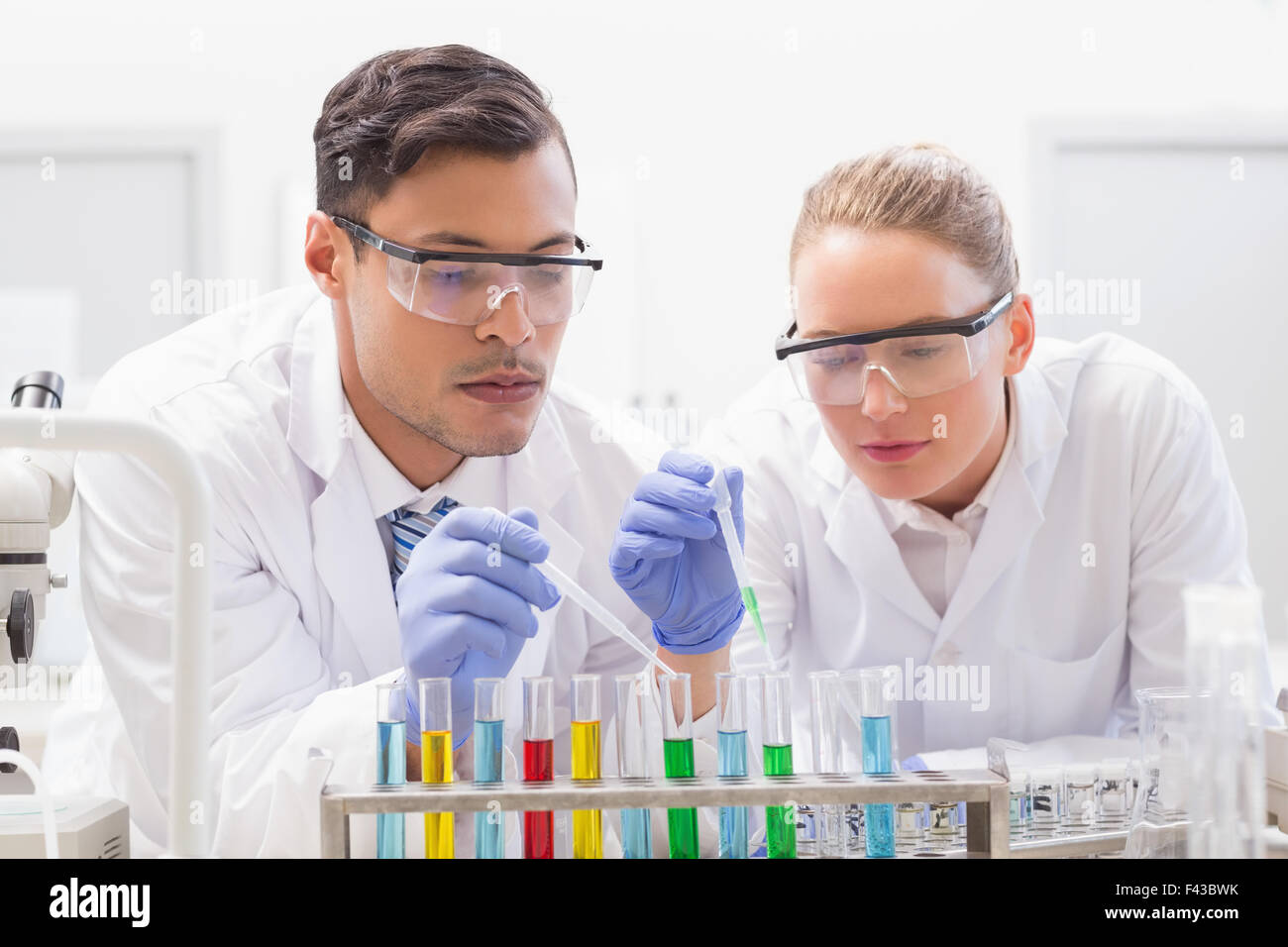Focused scientists examining test tube Stock Photo - Alamy