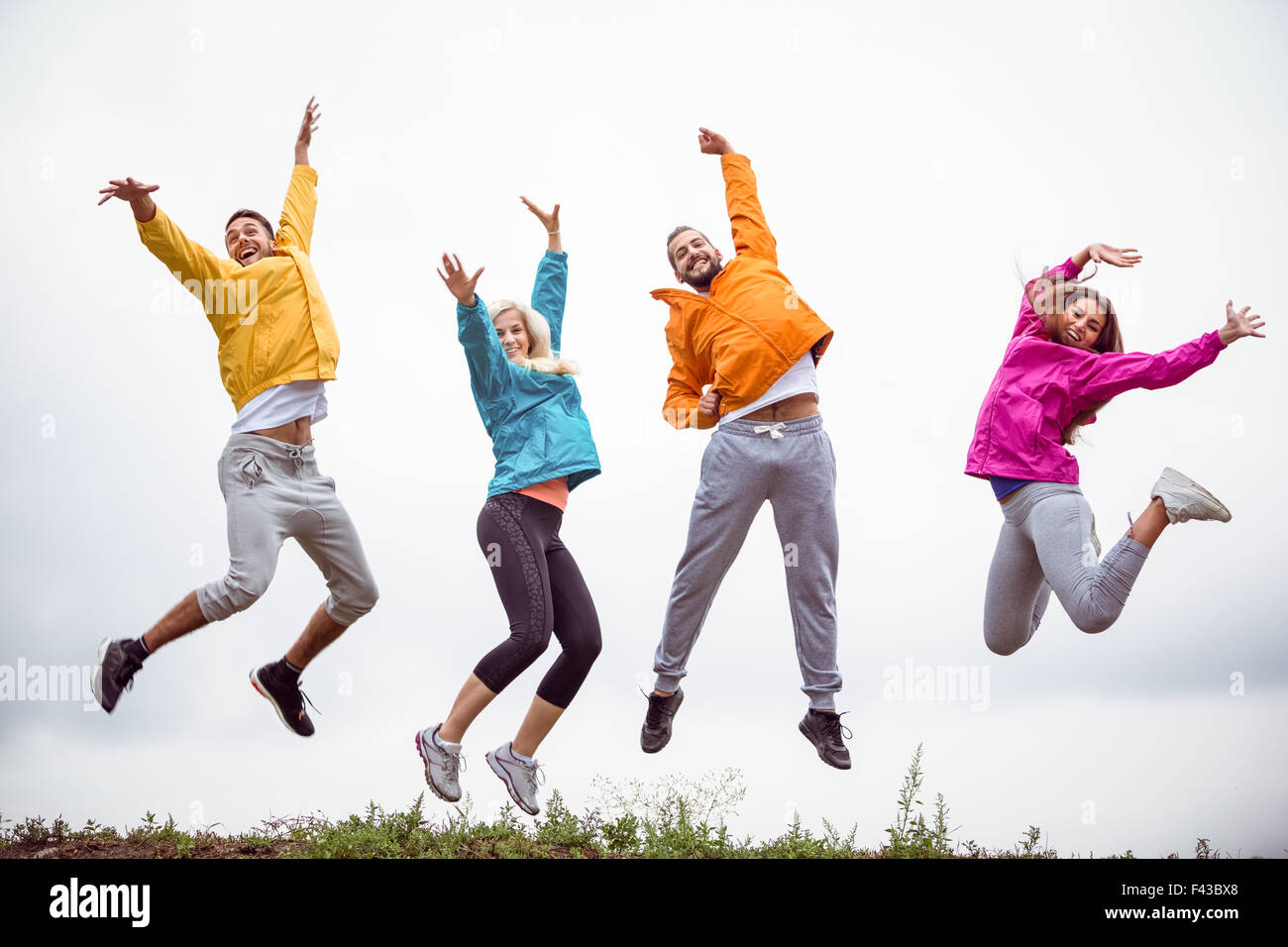 Friends jumping before a hike Stock Photo - Alamy