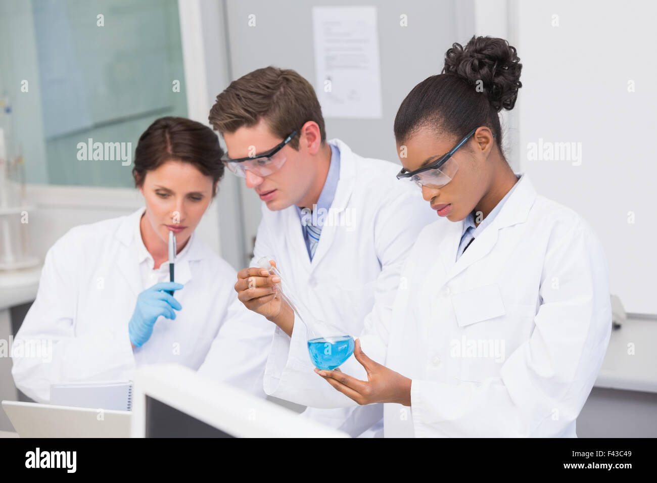 Concentrated scientists working together Stock Photo - Alamy