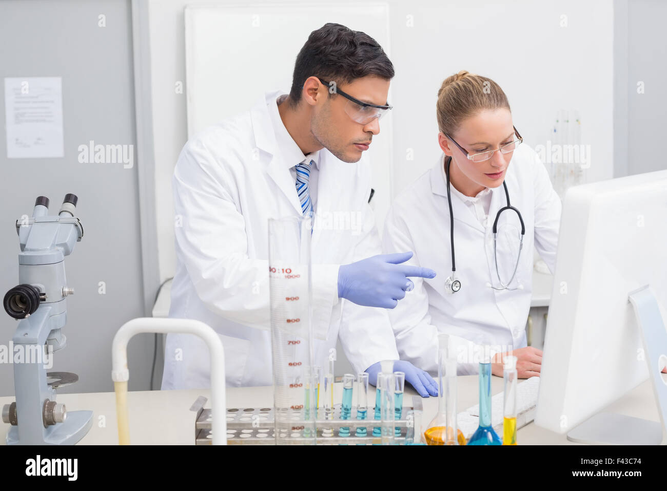 Scientists looking at computer Stock Photo - Alamy