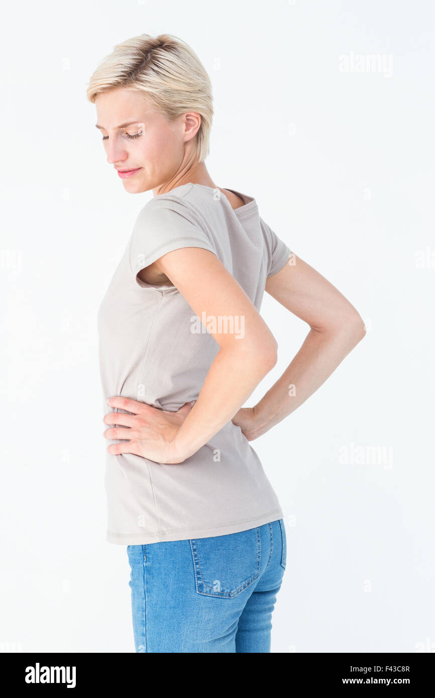 Blonde woman suffering from back pain Stock Photo - Alamy