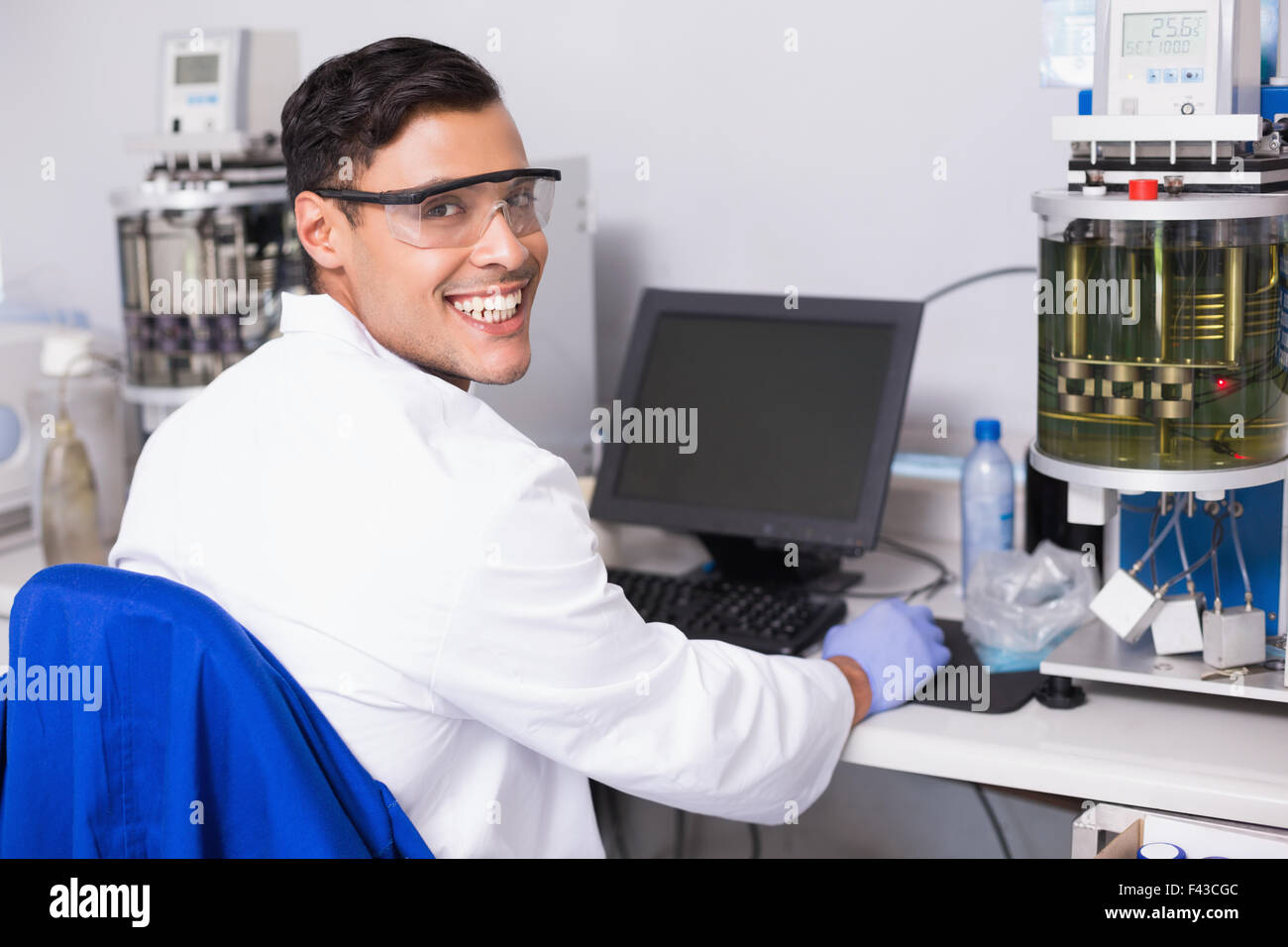 Smiling scientist working with computer Stock Photo - Alamy