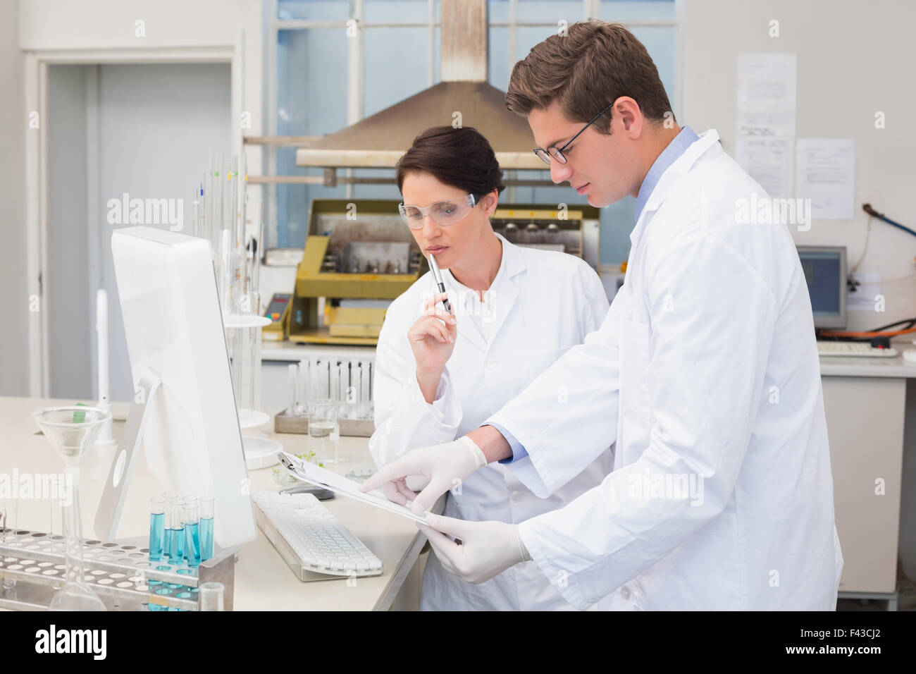 Scientists working attentively with computer Stock Photo - Alamy