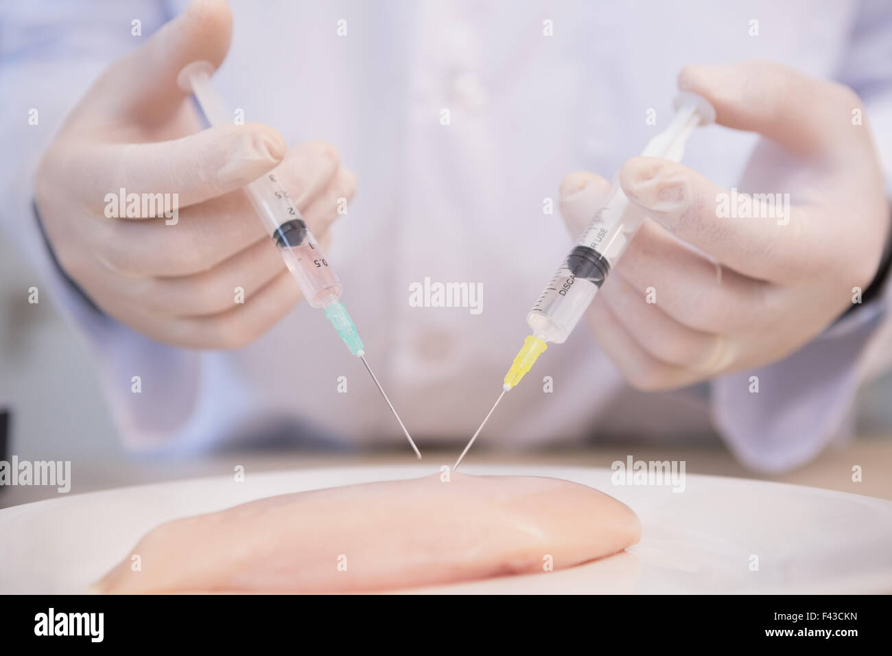 Scientist injecting piece of meat Stock Photo - Alamy
