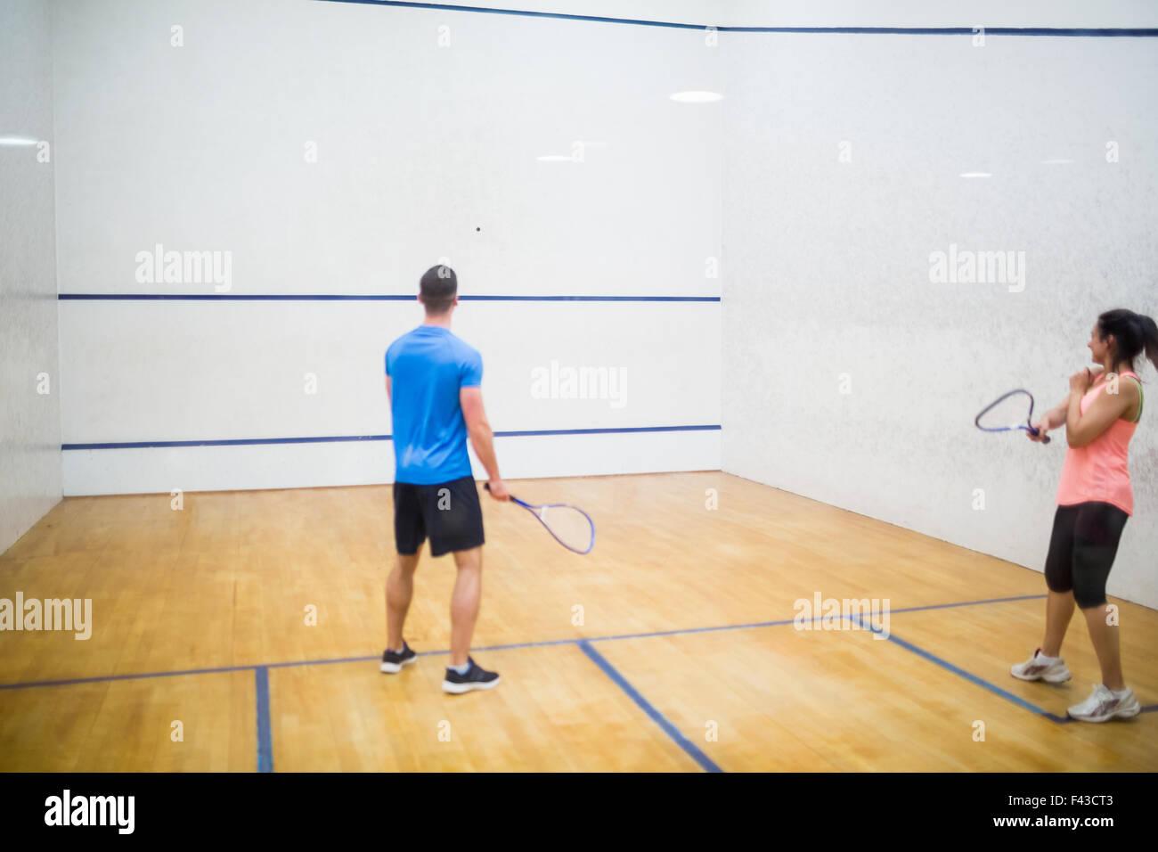 Couple play some squash together Stock Photo - Alamy