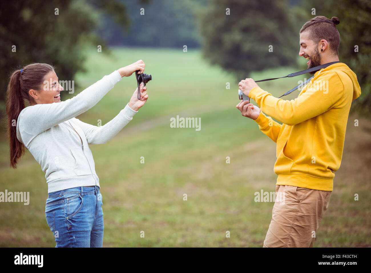 Happy couple taking photos of each other Stock Photo - Alamy