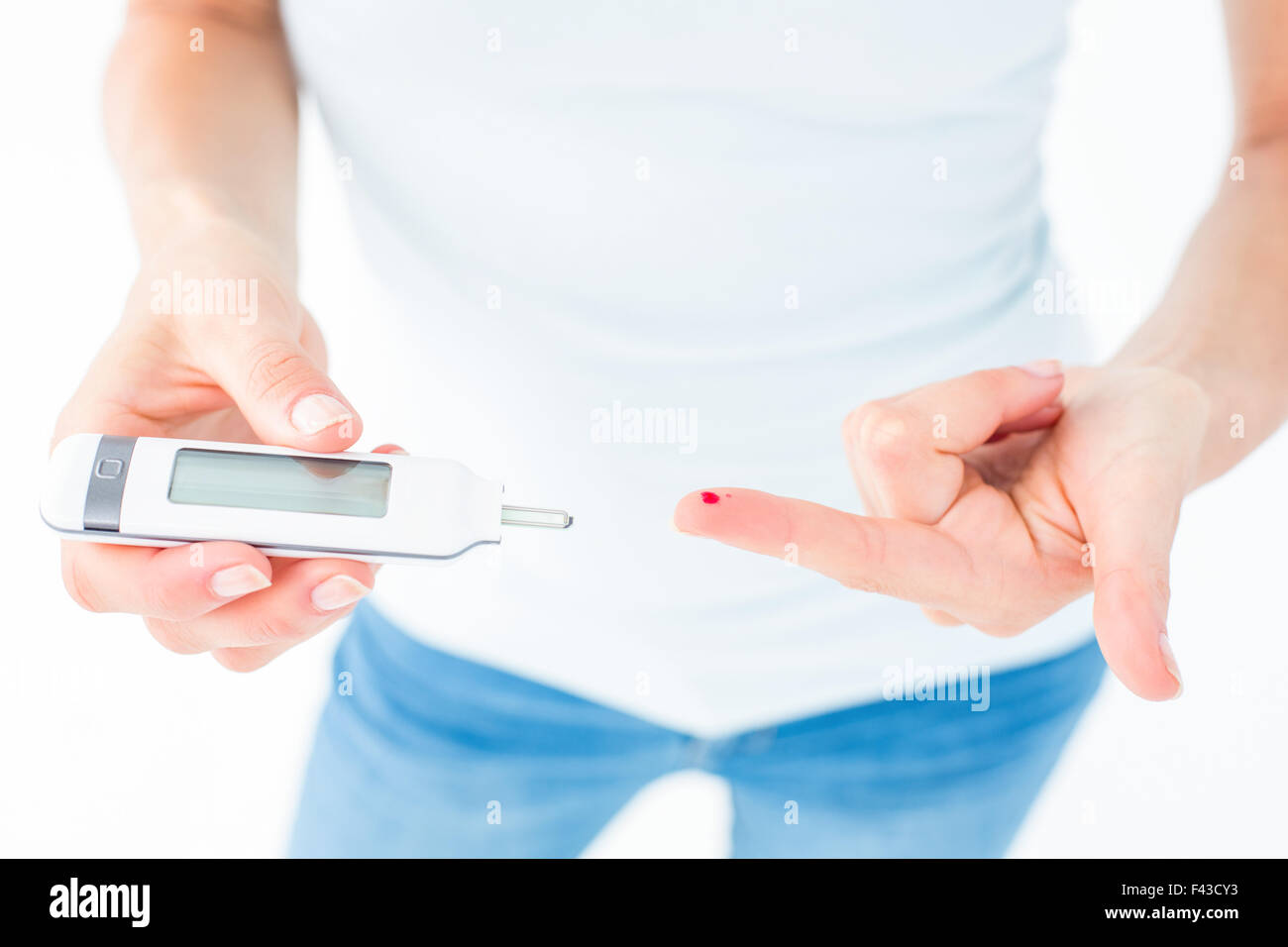 Woman testing her blood glucose level Stock Photo - Alamy