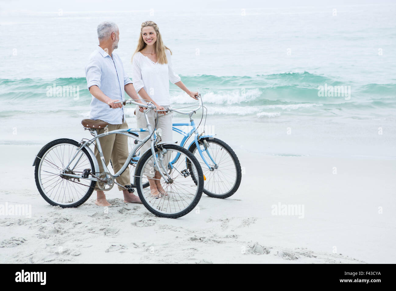 Happy couple cycling together Stock Photo - Alamy