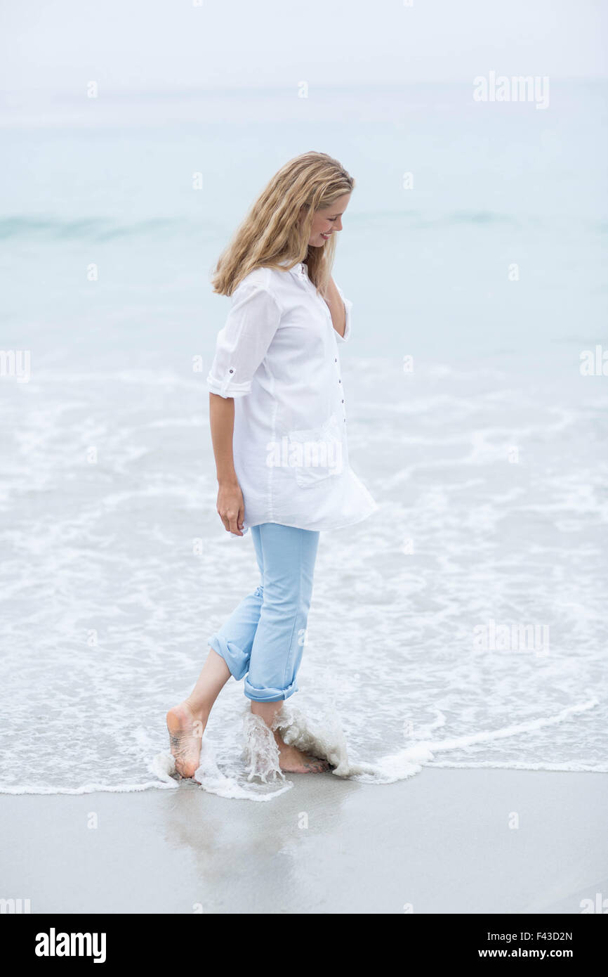 Smiling blonde walking sea hi-res stock photography and images - Alamy