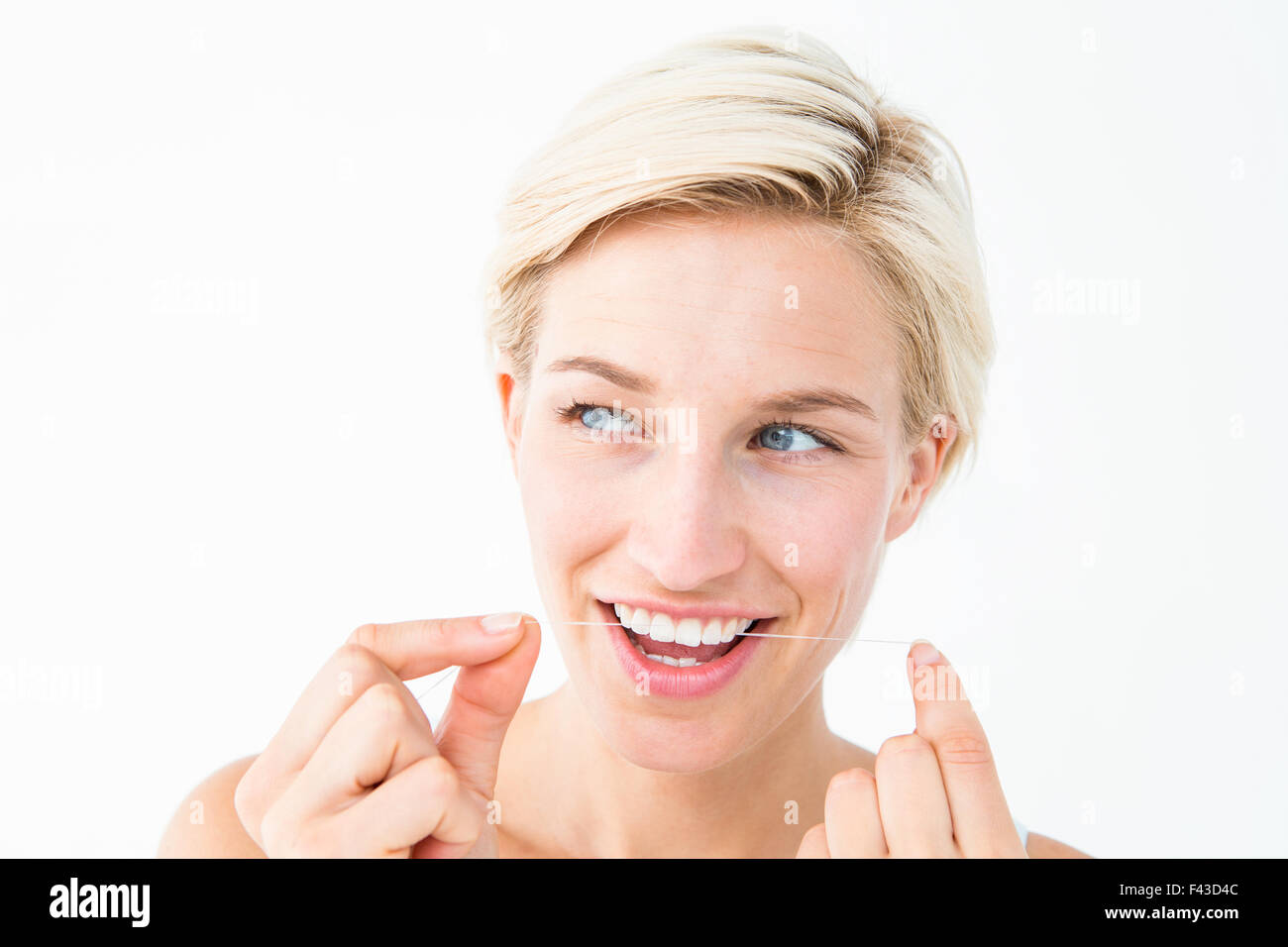 Beautiful blonde flossing Stock Photo - Alamy