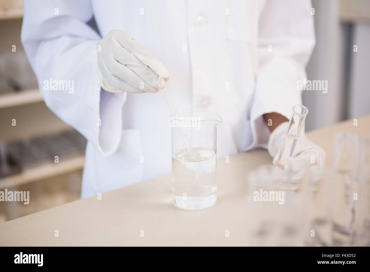 Scientist examining test tube and beaker Stock Photo - Alamy
