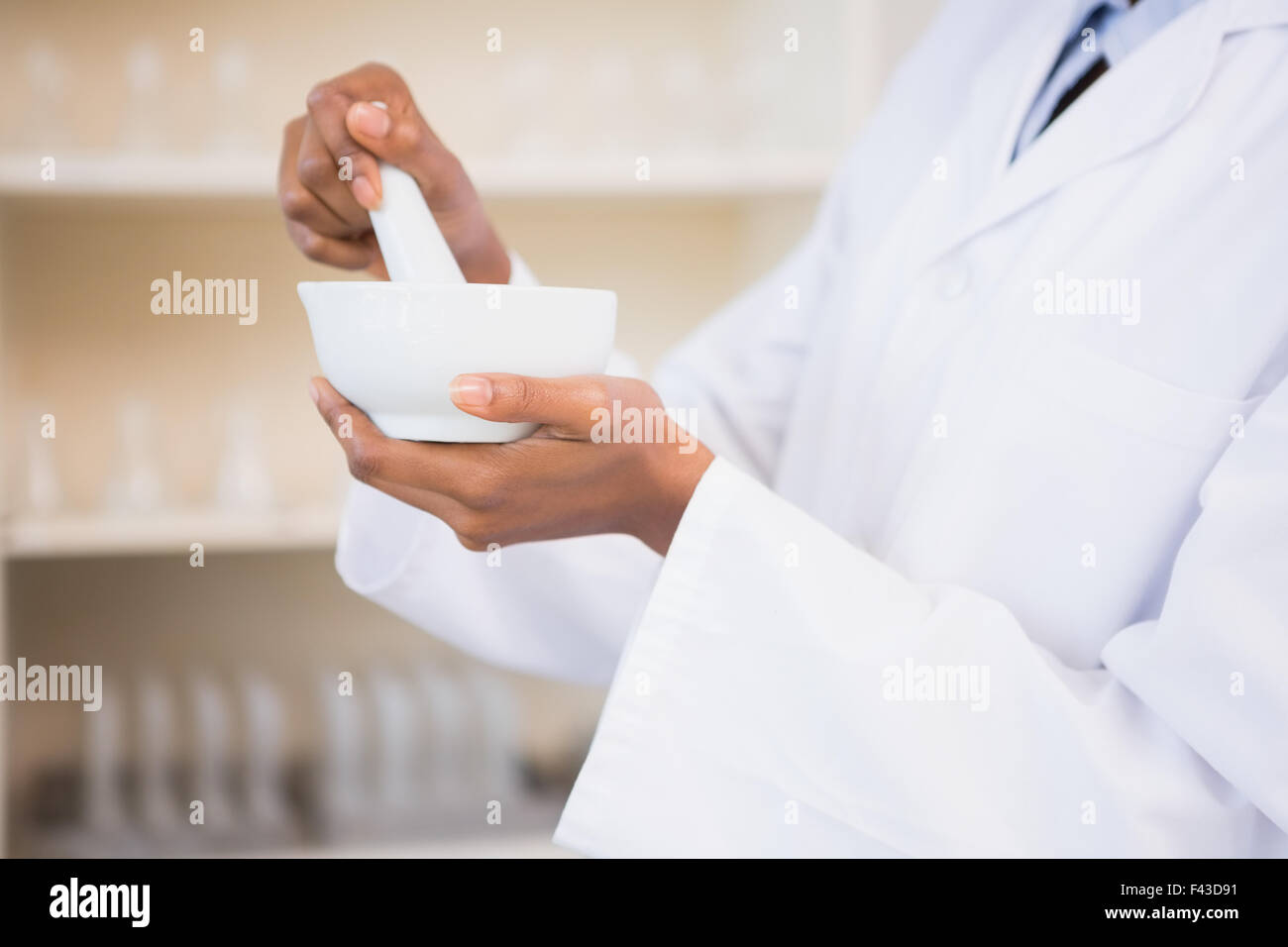 Scientist using pestle and mortar Stock Photo - Alamy