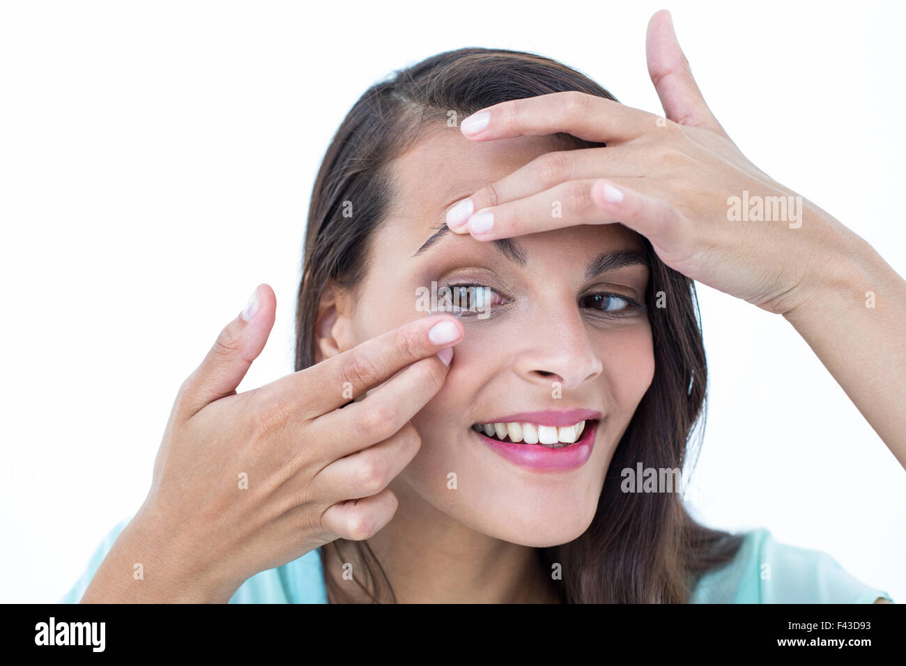 Beautiful woman applying contact lens Stock Photo - Alamy