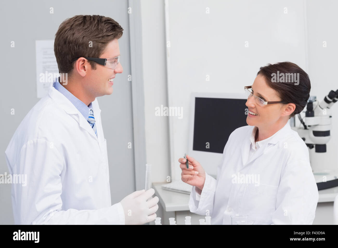 Scientists smiling at each other Stock Photo - Alamy