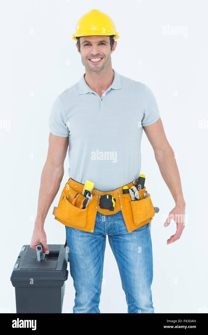 Confident technician holding tool box Stock Photo - Alamy