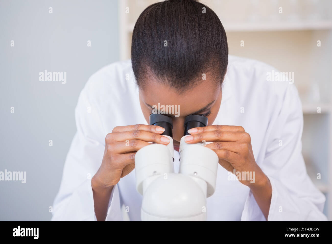 Scientist looking through a microscope Stock Photo - Alamy