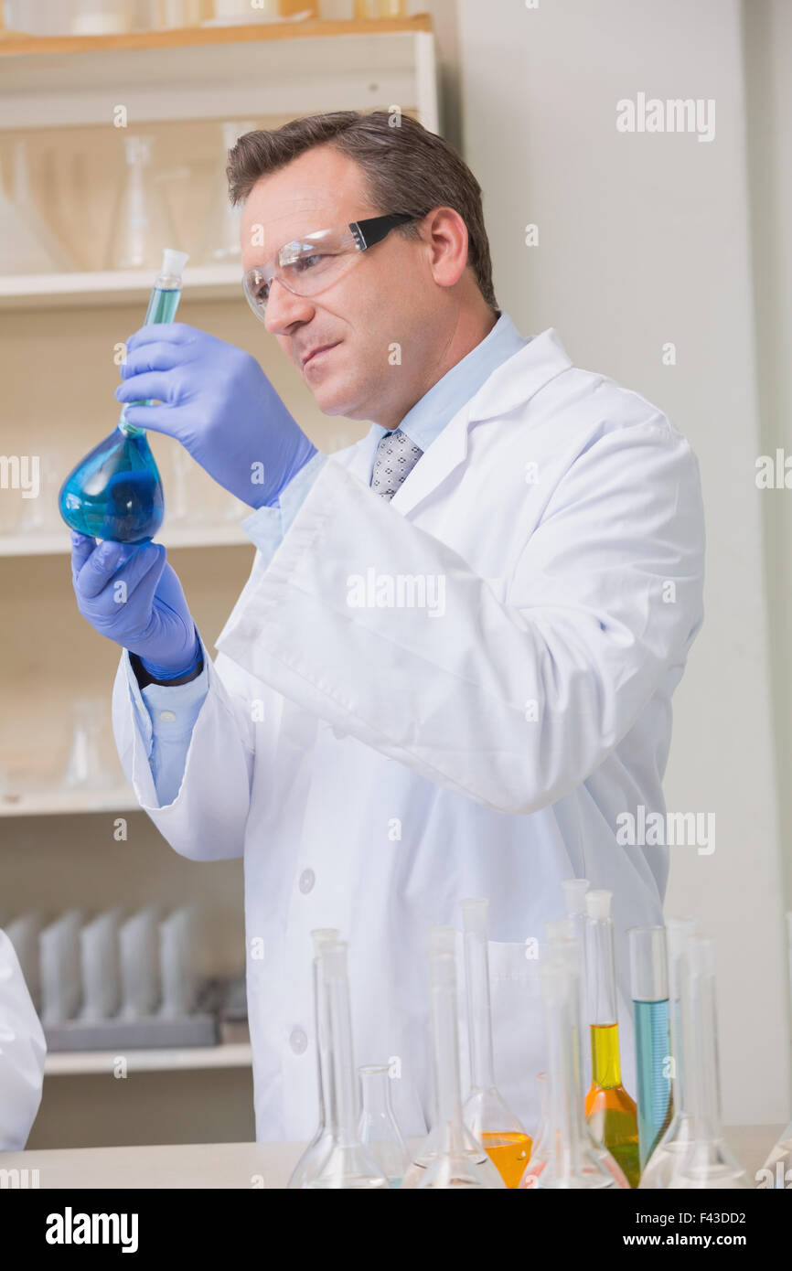 Scientist examining blue precipitate in baker Stock Photo - Alamy