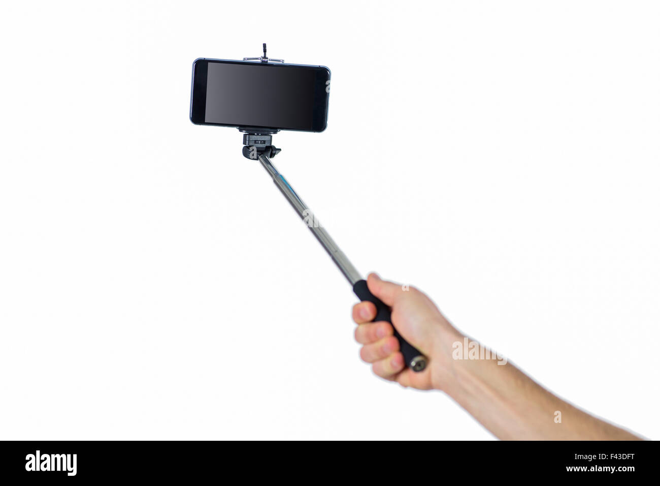 Man using a selfie stick Stock Photo - Alamy