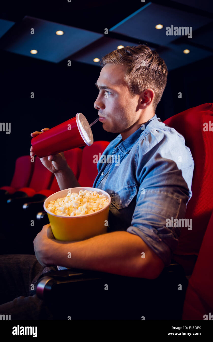 Young man watching a film Stock Photo - Alamy