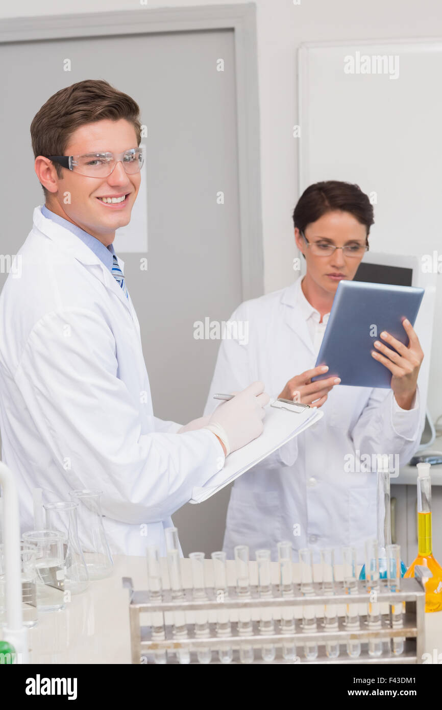 Smiling scientists using tablet Stock Photo - Alamy Smiling scientists using tablet Stock Photo - Alamy